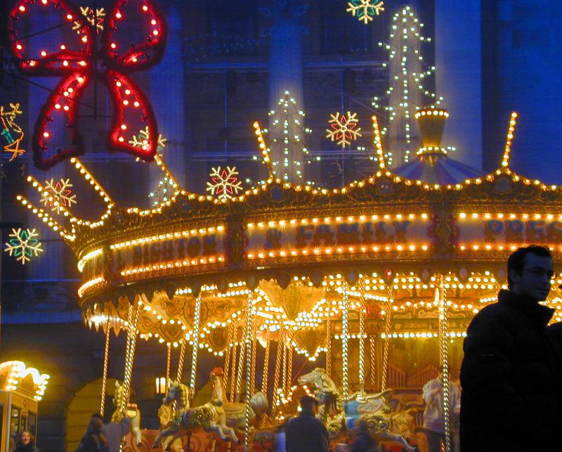 Free image of Colorful brightly lit merry-go-round at a fair